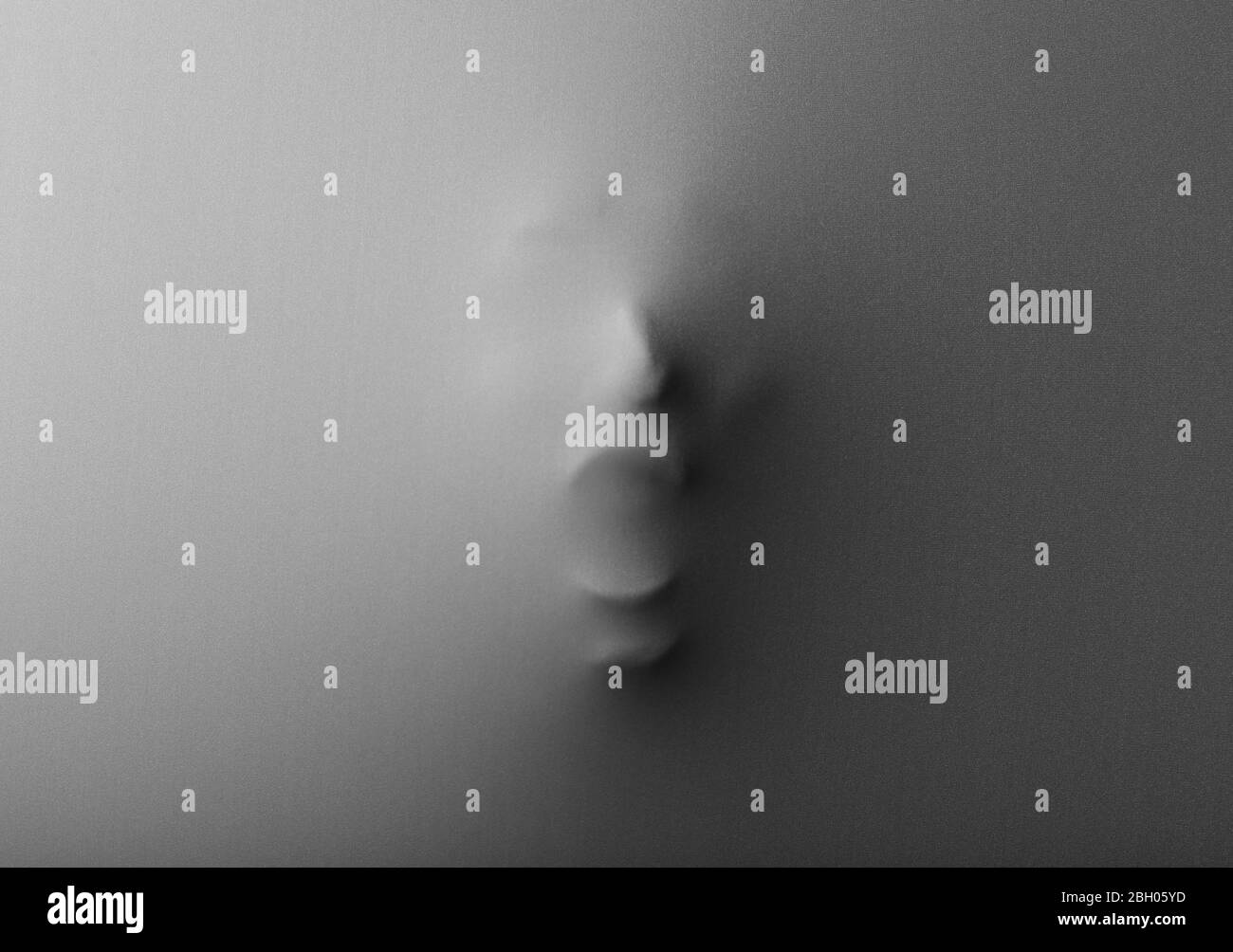 Screaming human face pressing through fabric as horror background Stock ...