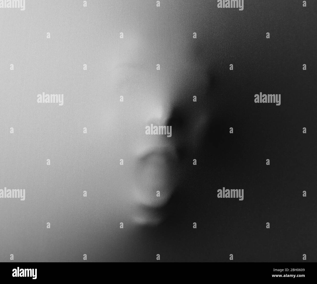 Screaming human face pressing through fabric as horror background Stock ...