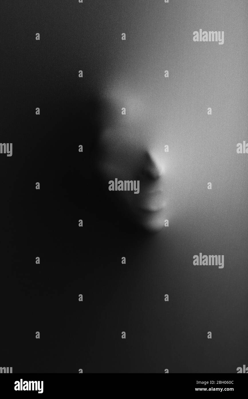 Human face pressing through fabric as horror background Stock Photo - Alamy