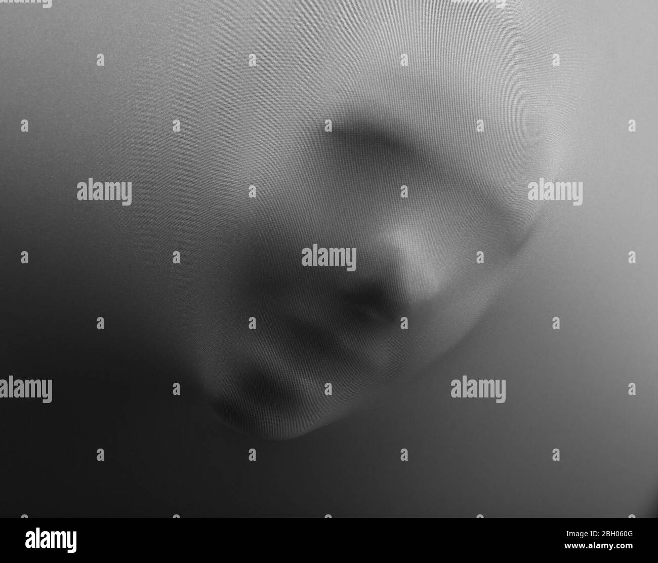 Screaming human face pressing through fabric as horror background Stock ...