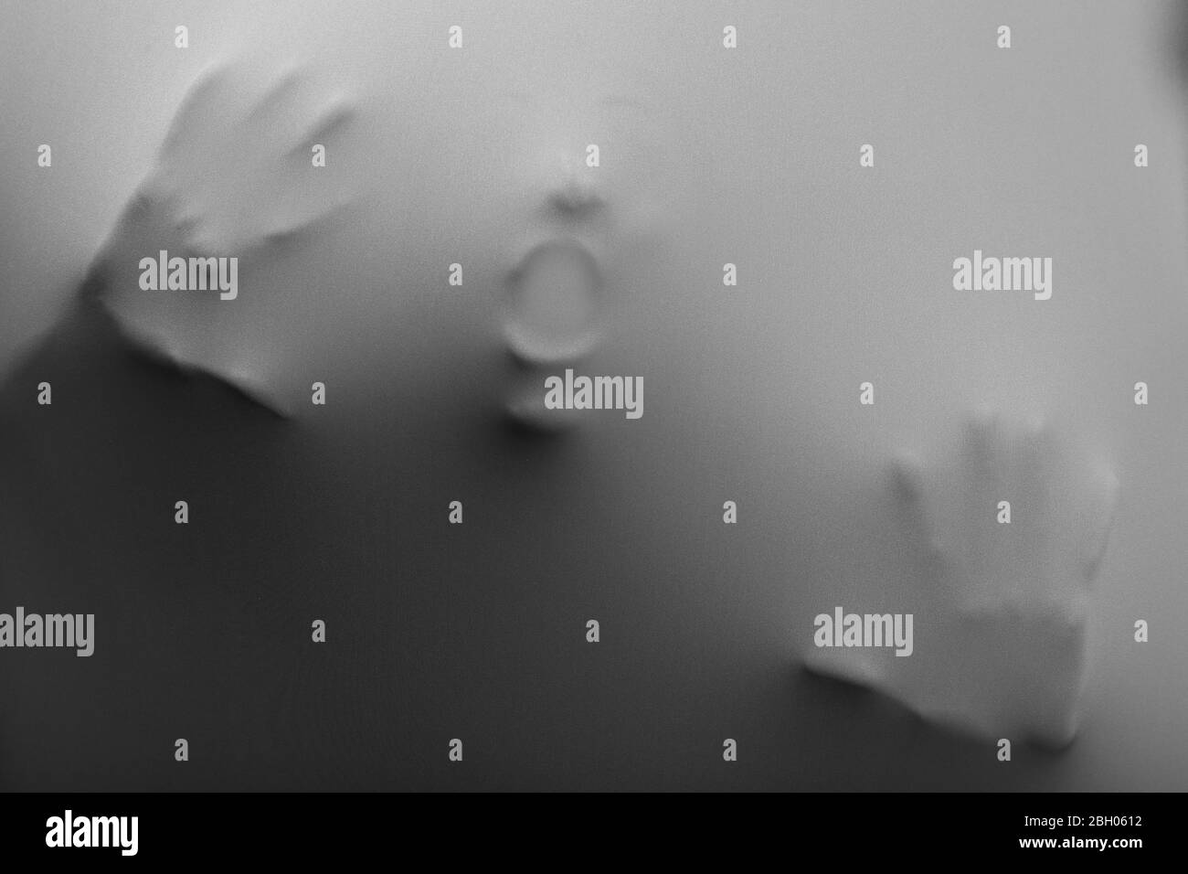 Screaming human face with hands pressing through fabric as horror ...