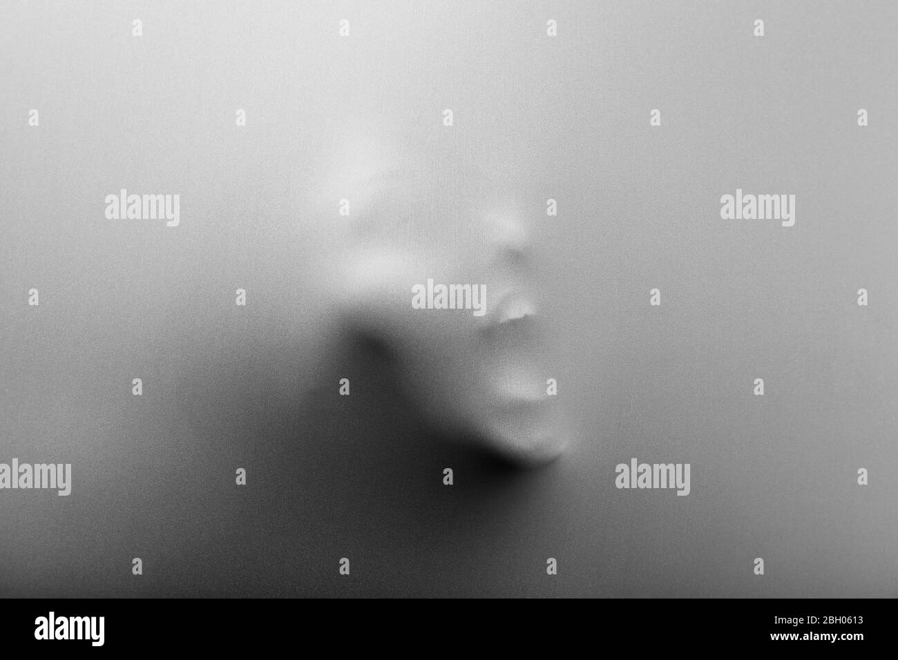 Screaming human face pressing through fabric as horror background Stock ...