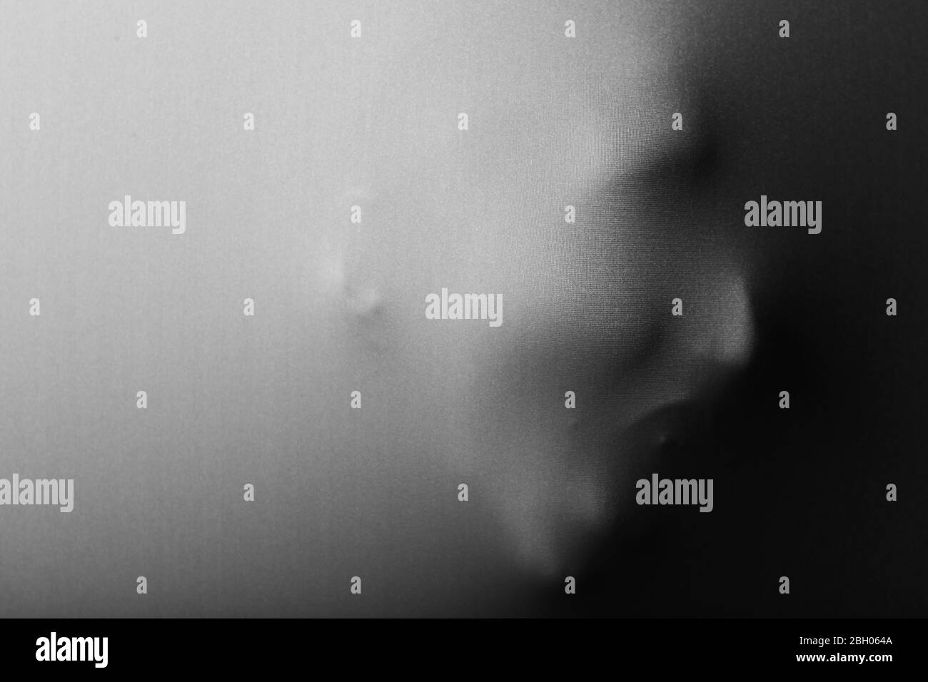 Human face screaming pressing through fabric as horror background Stock ...