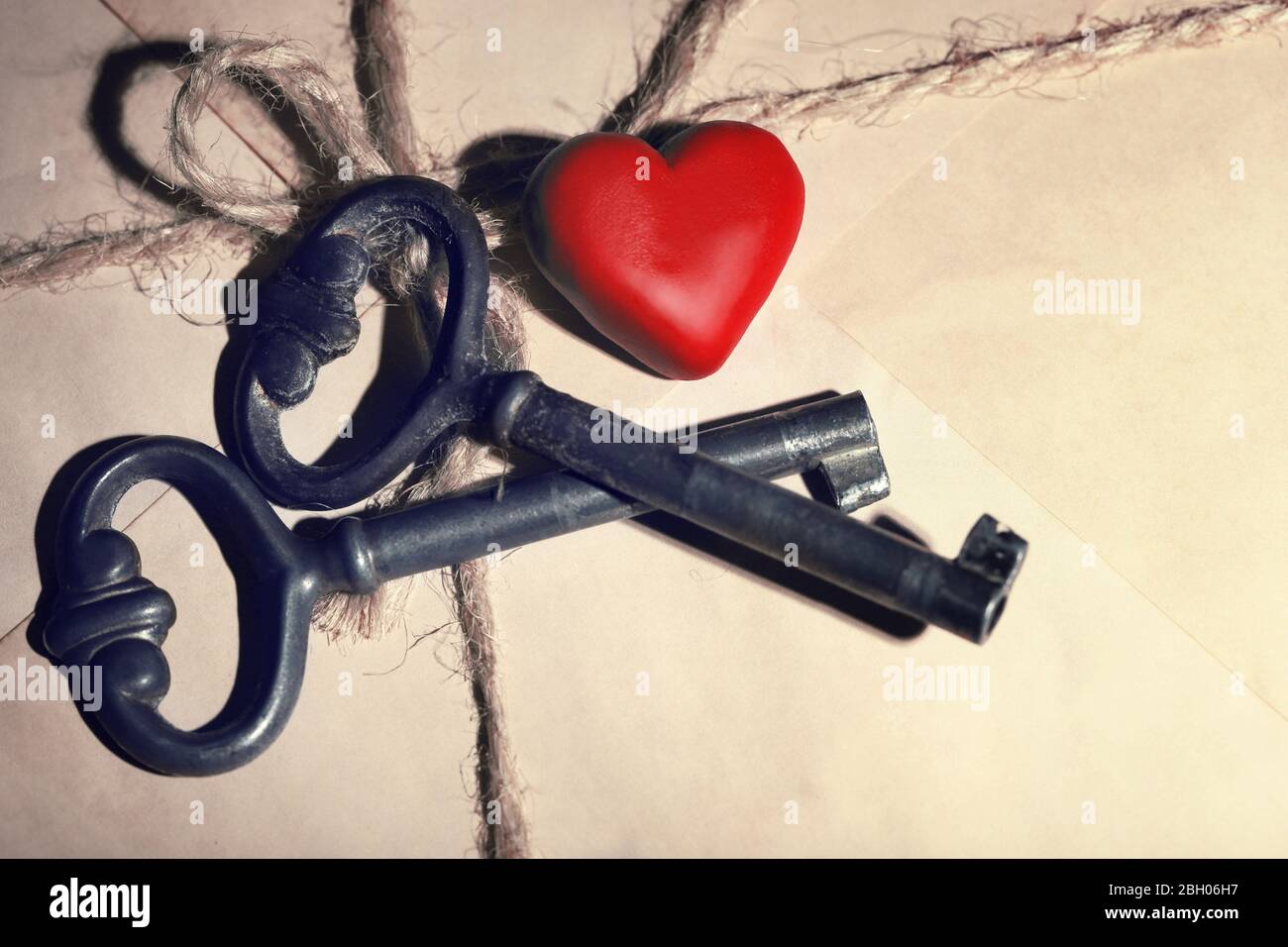 Keys with heart on stack of letters as background Stock Photo - Alamy