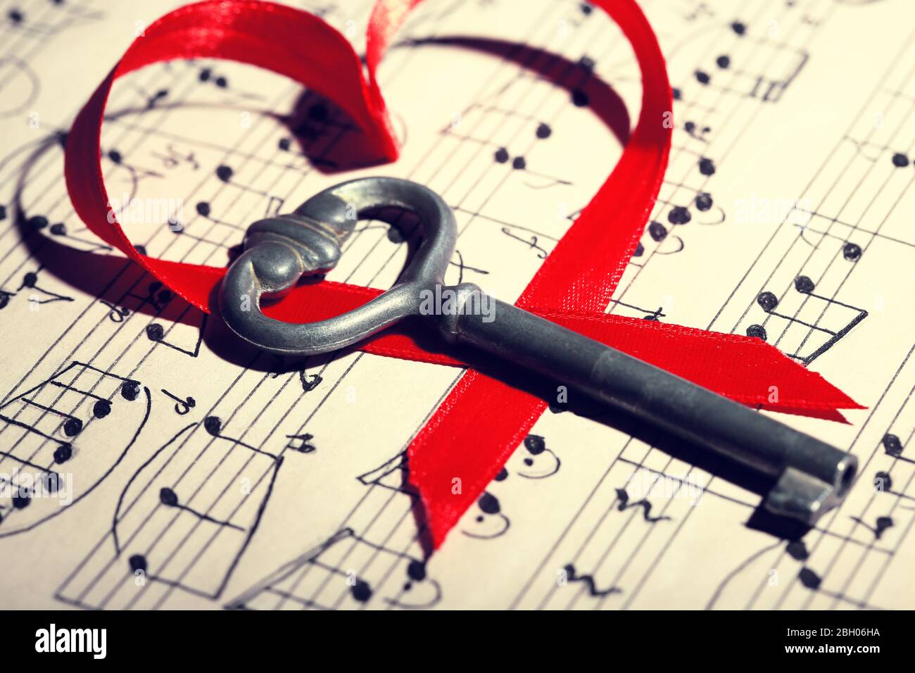 Retro key with heart on music book background Stock Photo - Alamy