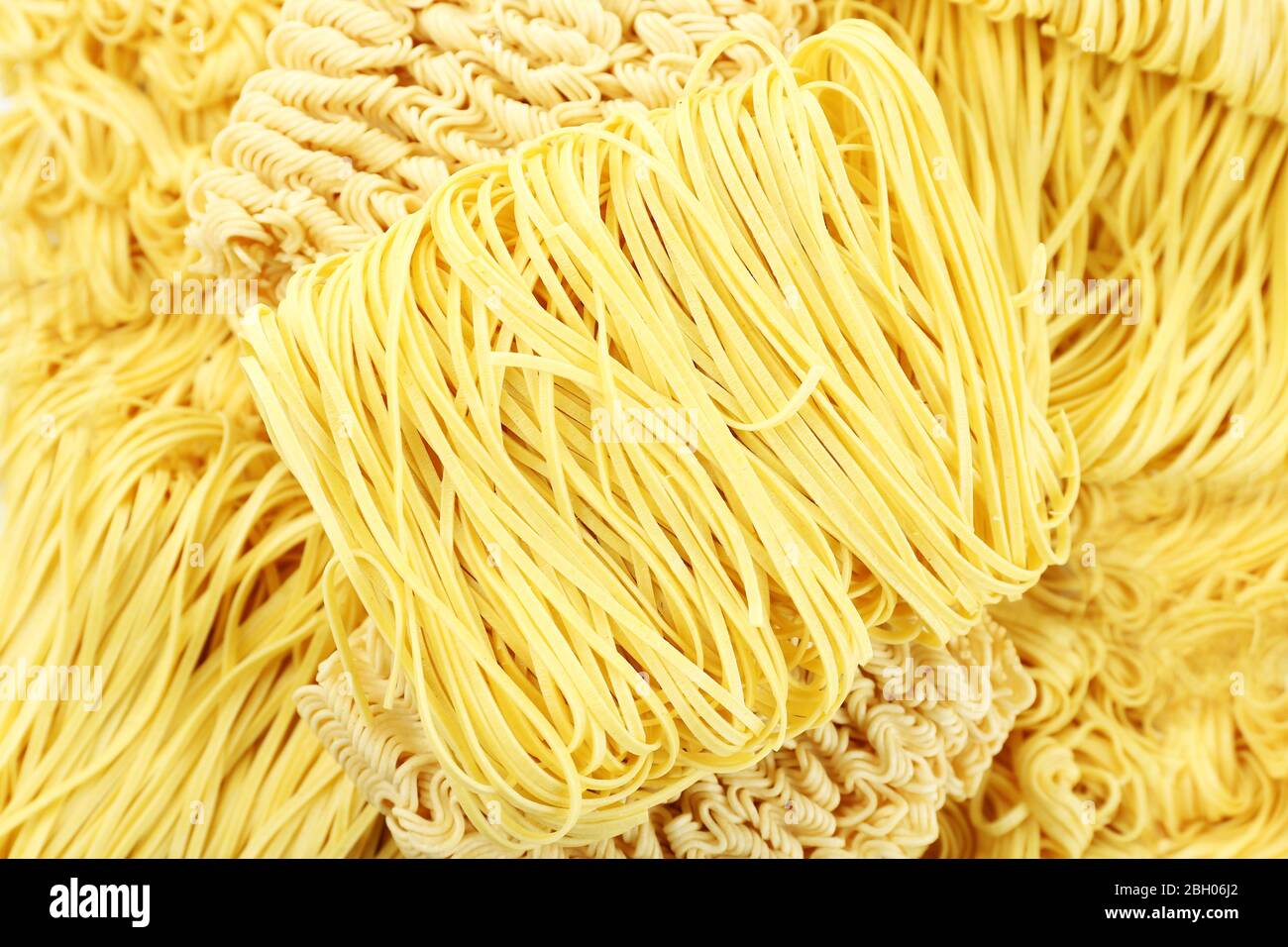 Different dry instant noodles close-up background Stock Photo - Alamy