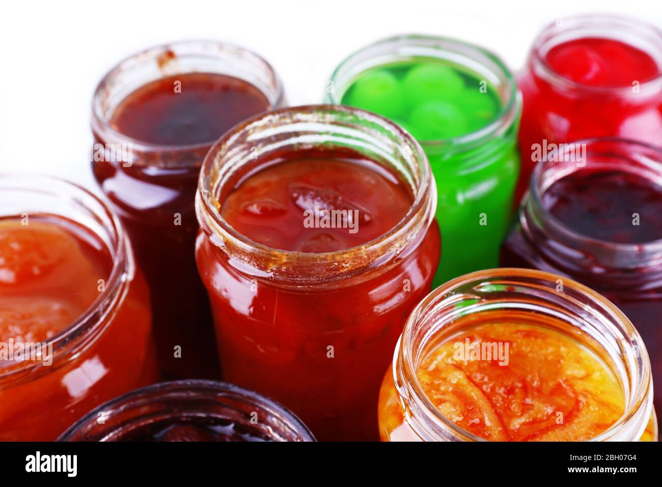 Homemade jars of fruits jam on color table background Stock Photo - Alamy