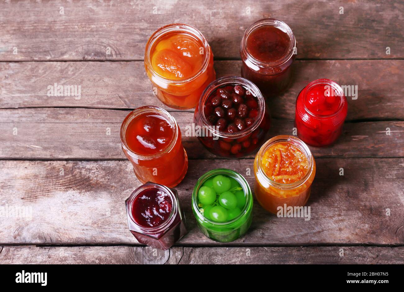 Homemade jars of fruits jam on rustic wooden background Stock Photo - Alamy