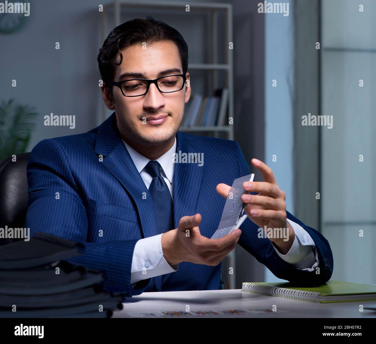 The young business playing cards late in office Stock Photo - Alamy