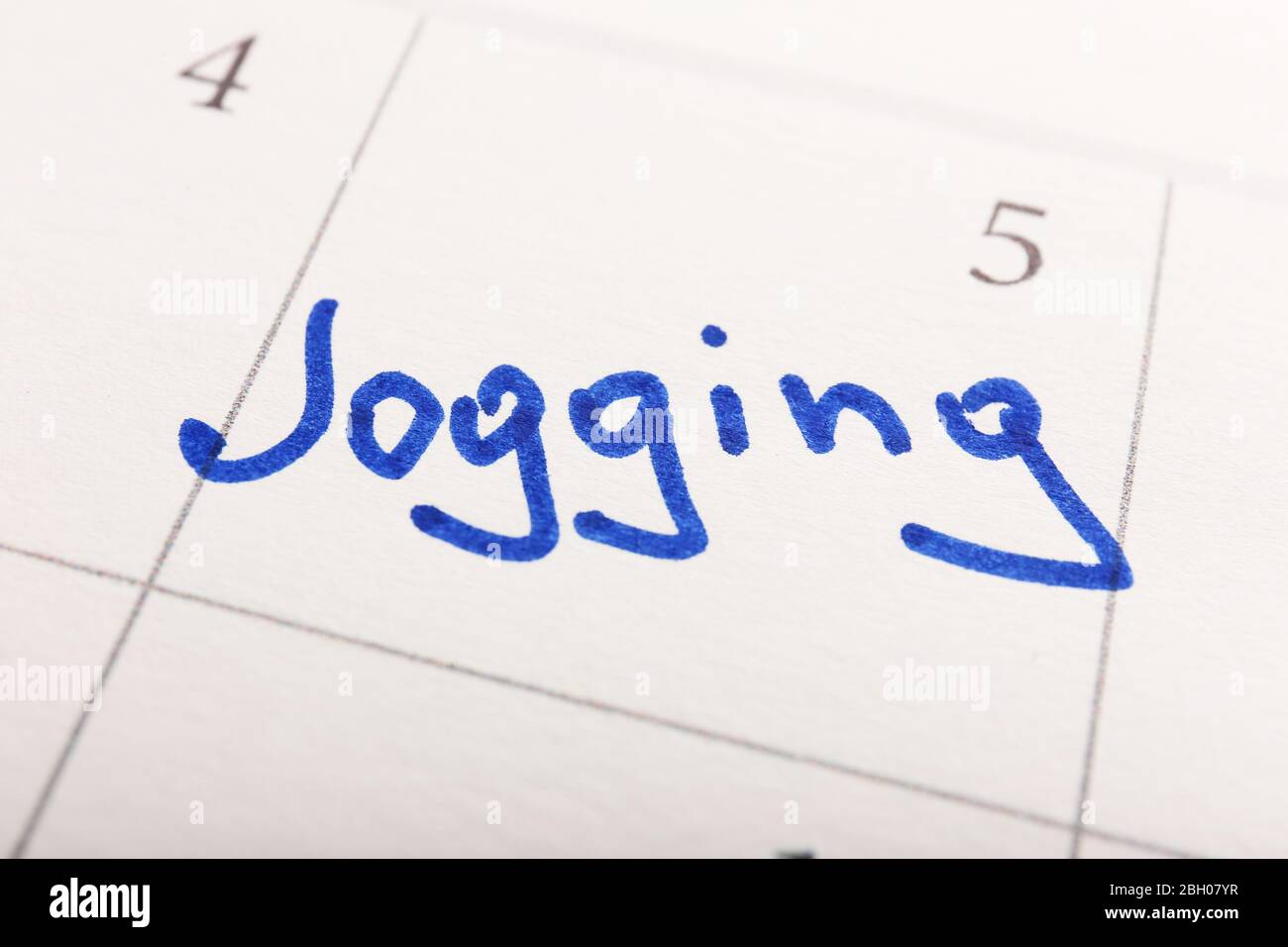 Written plan Jogging on calendar page background Stock Photo - Alamy