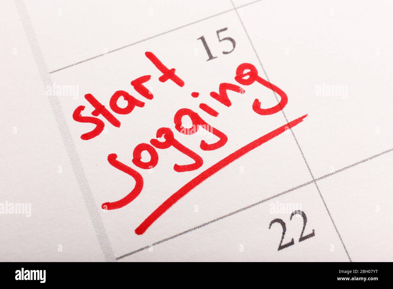 Written plan Start Jogging on calendar page background Stock Photo - Alamy