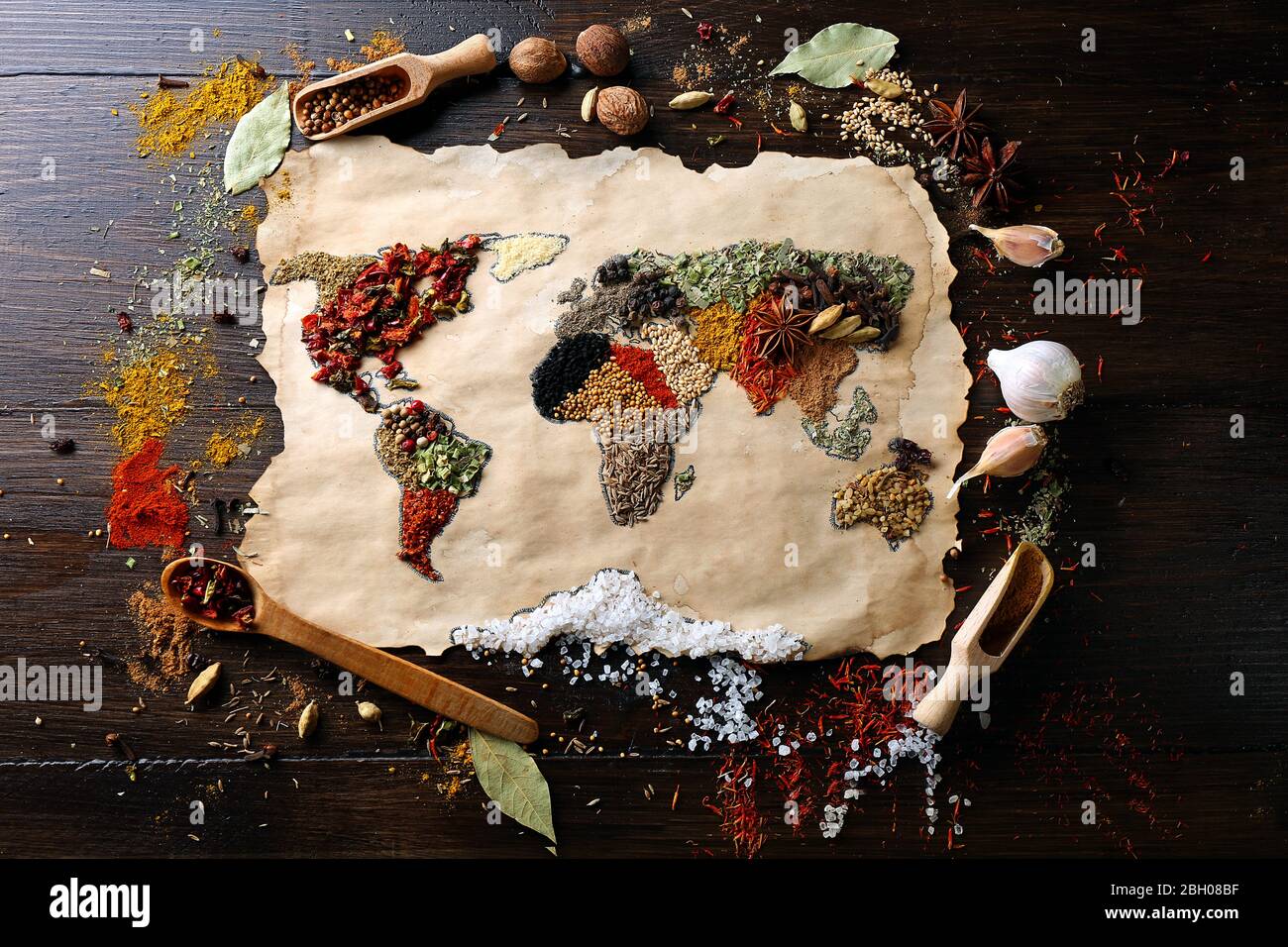 Map of world made from different kinds of spices on wooden background ...