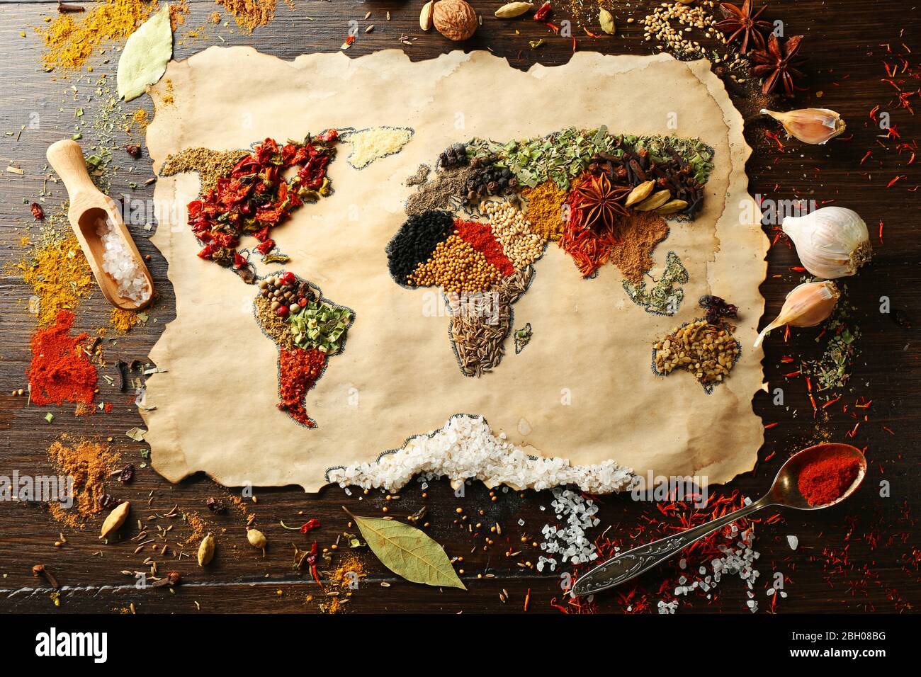 Map of world made from different kinds of spices on wooden background ...