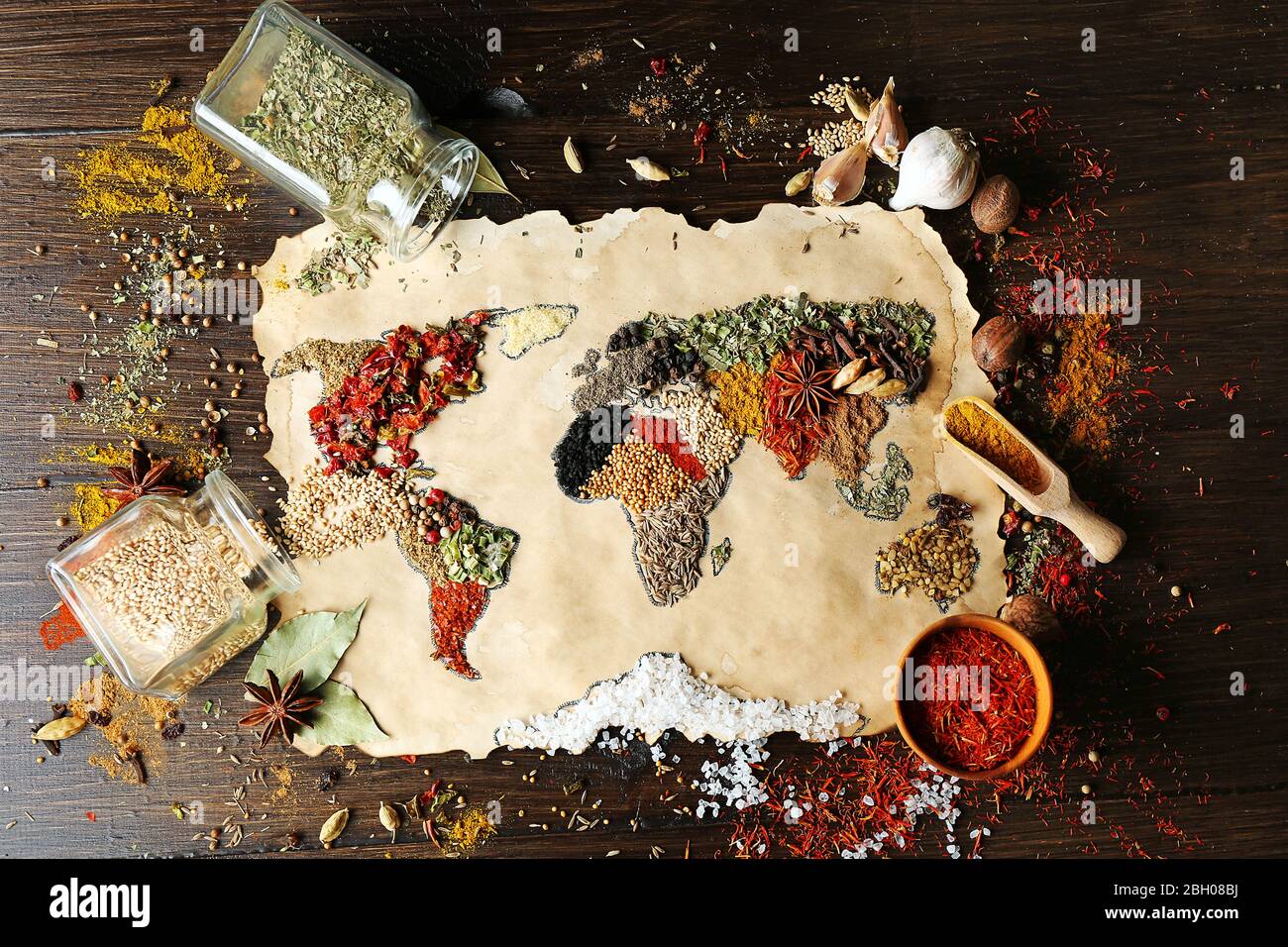 Map of world made from different kinds of spices on wooden background ...