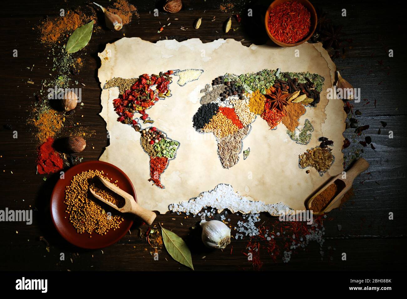 Map of world made from different kinds of spices on wooden background ...