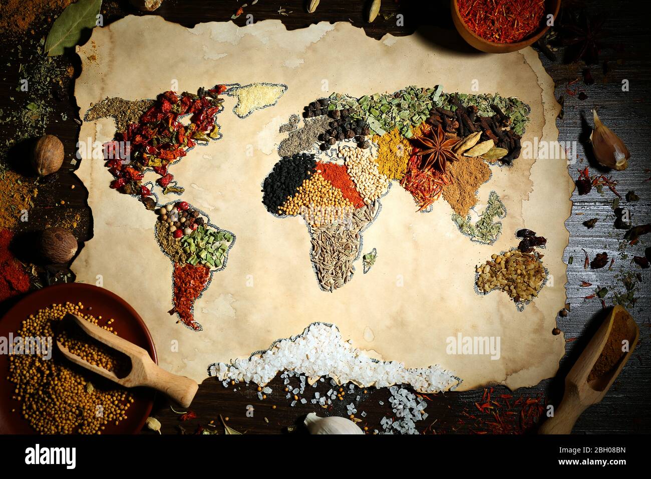 Map of world made from different kinds of spices on wooden background ...