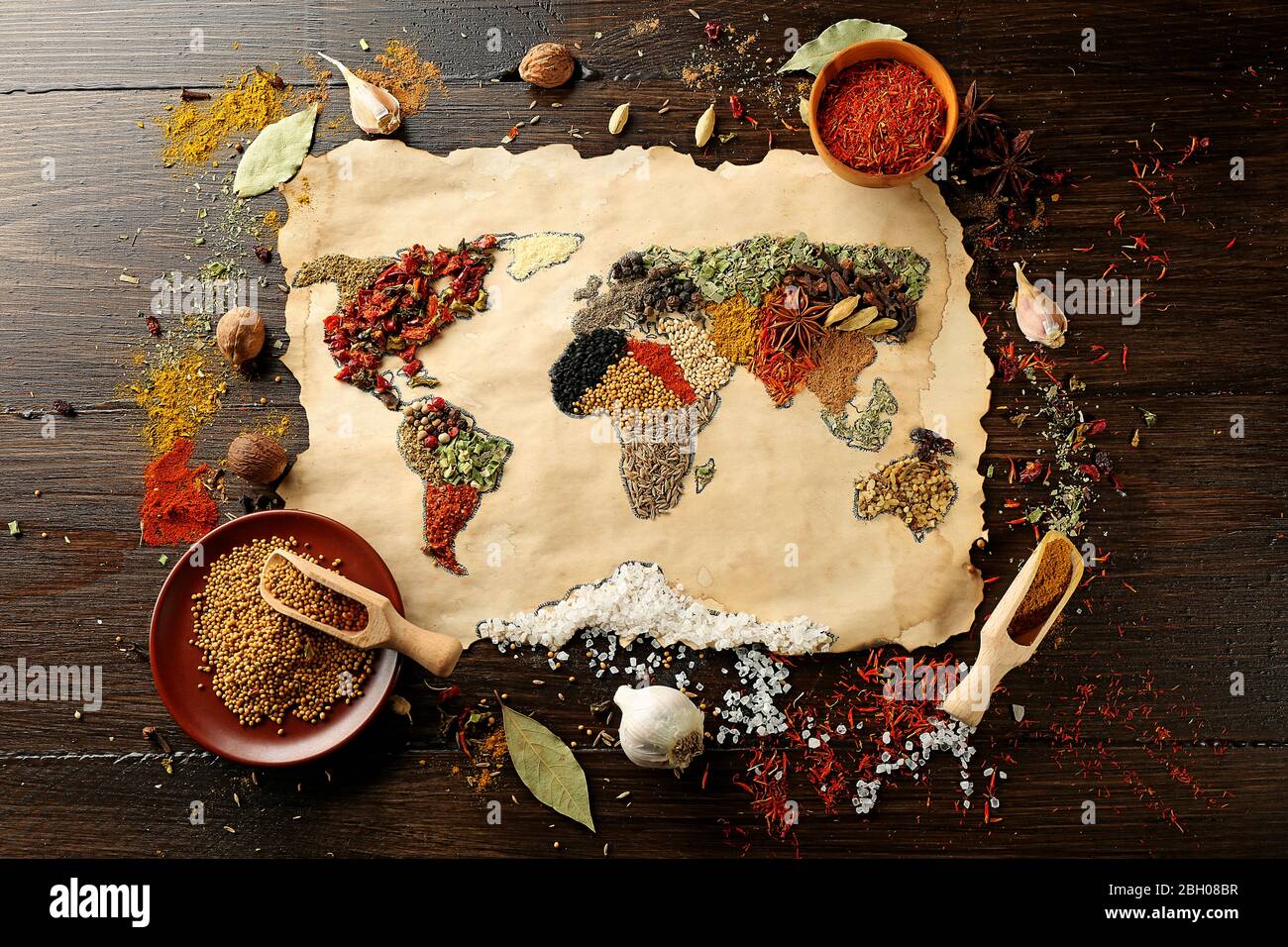 Map of world made from different kinds of spices on wooden background ...