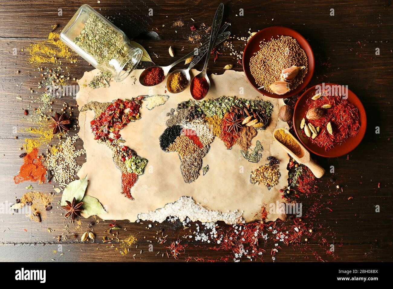 Map of world made from different kinds of spices on wooden background ...