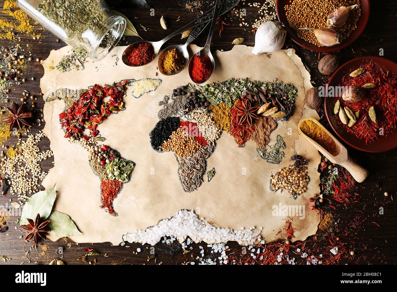 Map of world made from different kinds of spices on wooden background ...