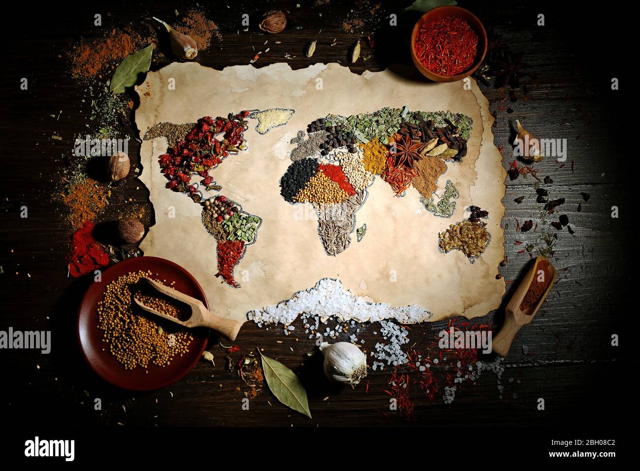 Map of world made from different kinds of spices on wooden background ...