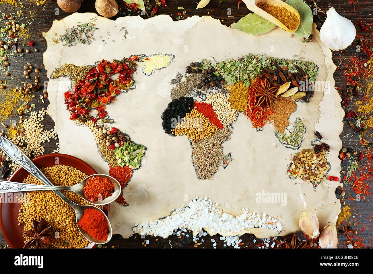Map of world made from different kinds of spices on wooden background ...