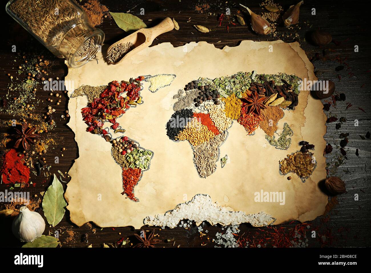 Map of world made from different kinds of spices on wooden background ...