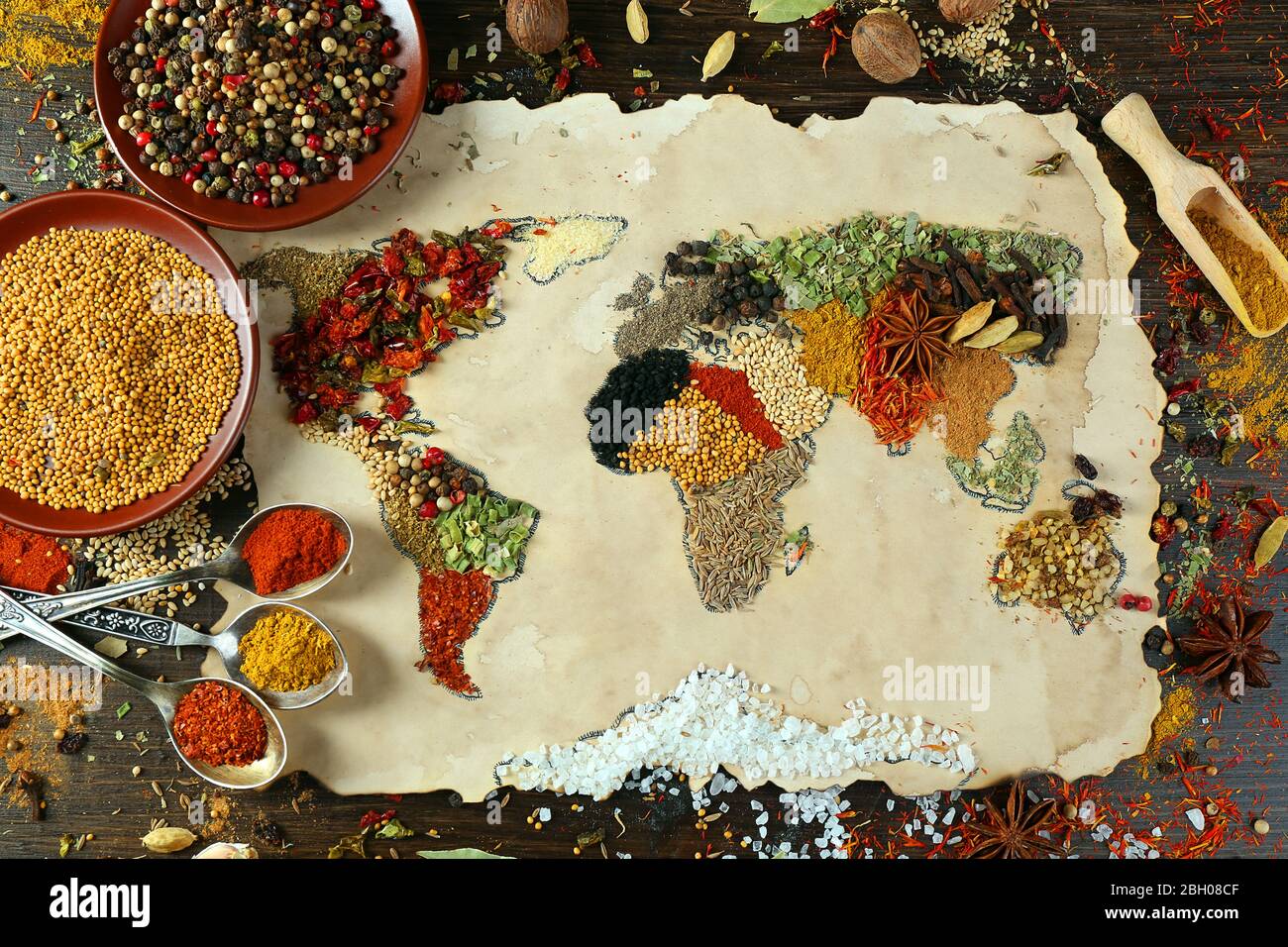 Map of world made from different kinds of spices on wooden background ...