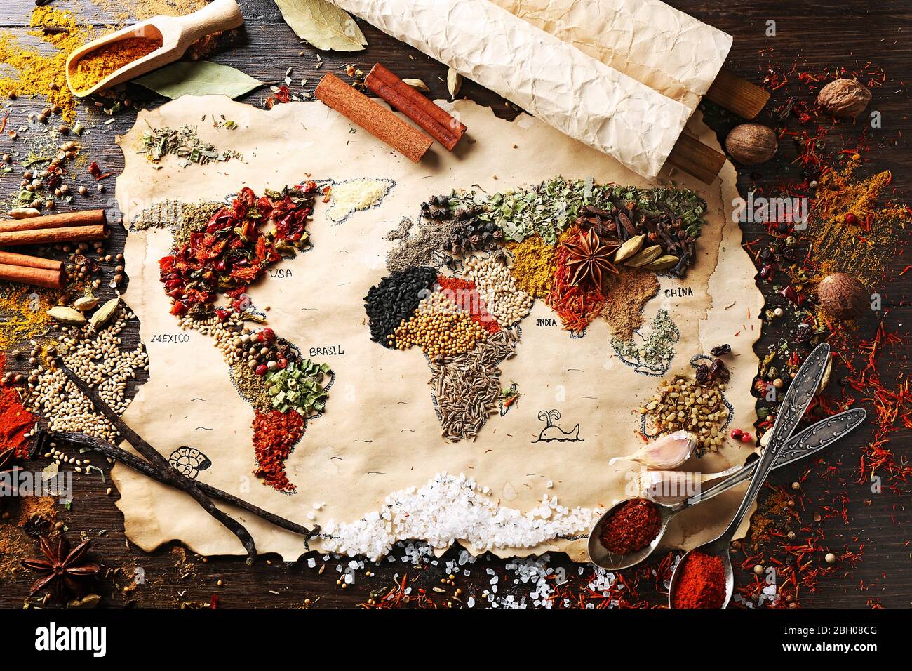 Map of world made from different kinds of spices on wooden background ...