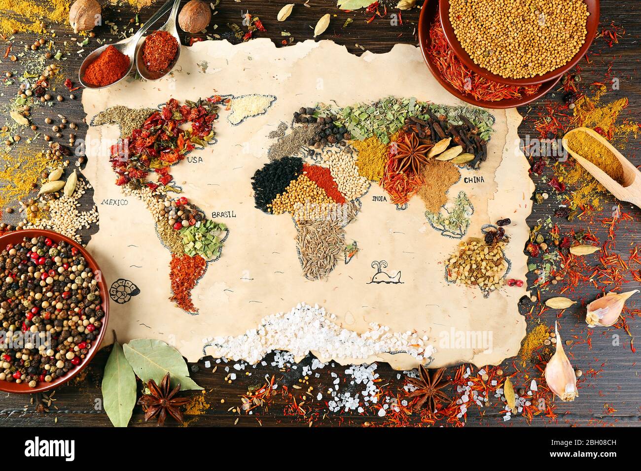 Map of world made from different kinds of spices on wooden background ...