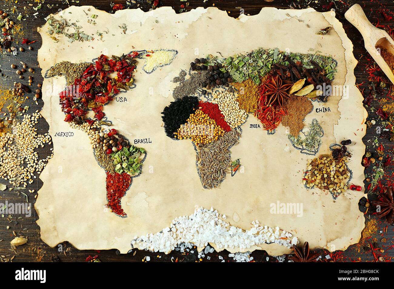 Map of world made from different kinds of spices on wooden background ...