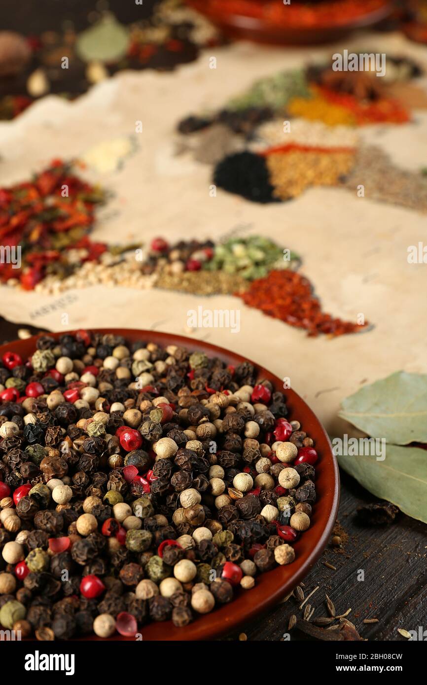 Map of world made from different kinds of spices on wooden background ...