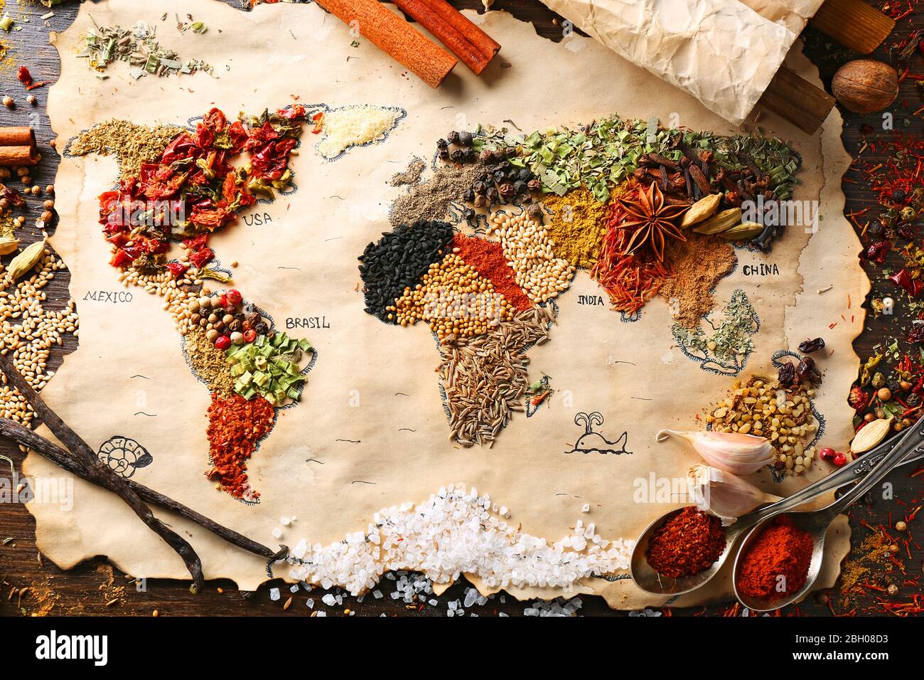 Map of world made from different kinds of spices on wooden background ...