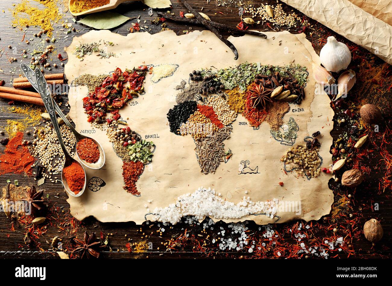 Map of world made from different kinds of spices on wooden background ...