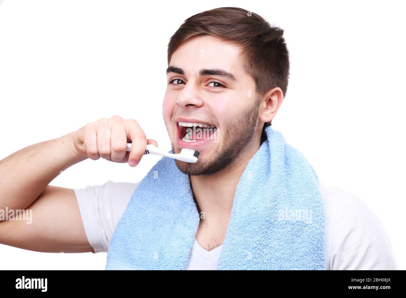 Portrait of smiling young man with toothbrush isolated on white Stock ...