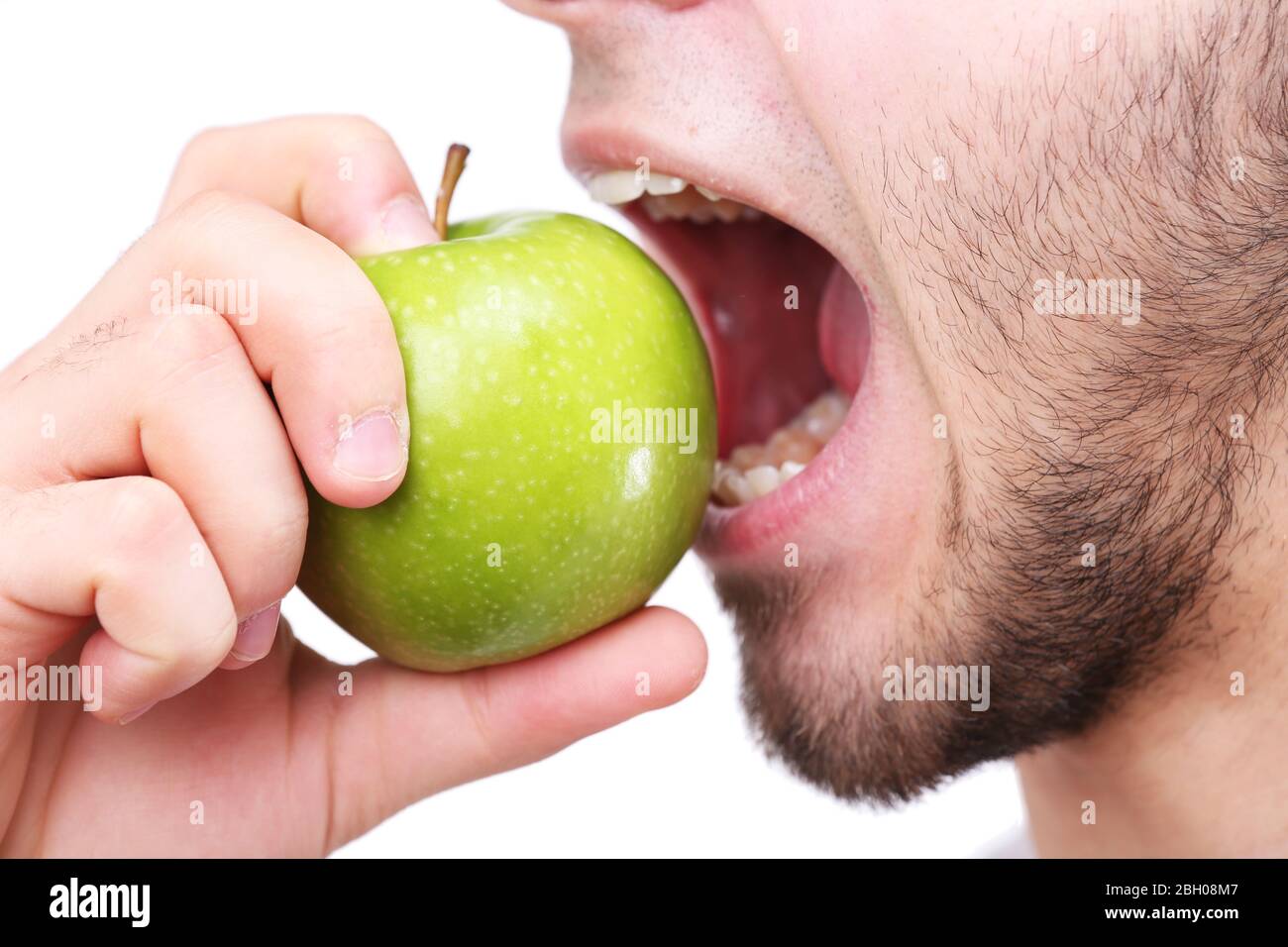 Man biting fresh green apple with healthy teeth isolated on white ...
