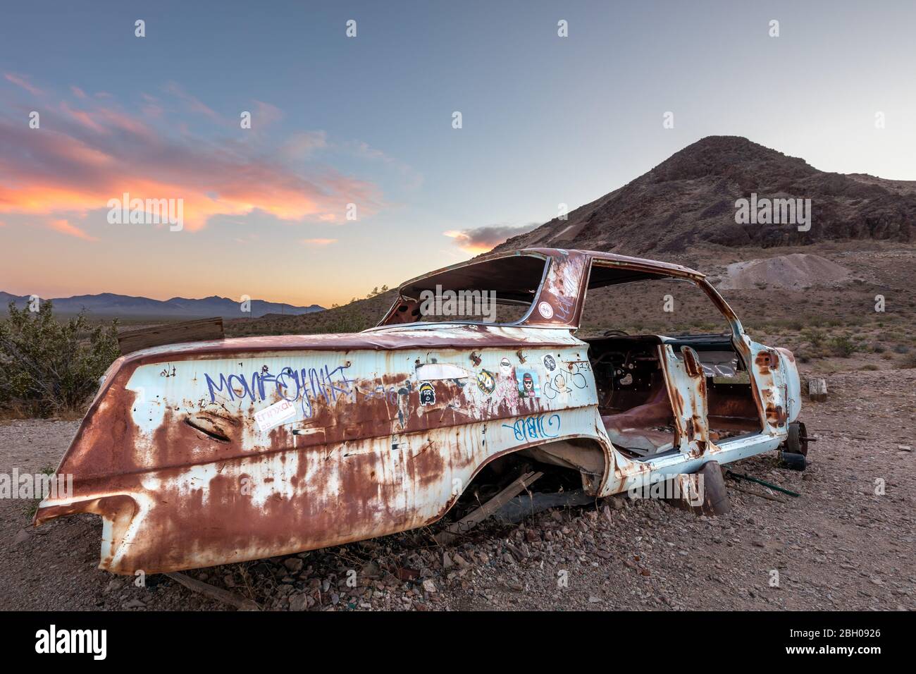 A wrecked, rusty sedan car in Rhyolite ghost town, Death Valley, at ...