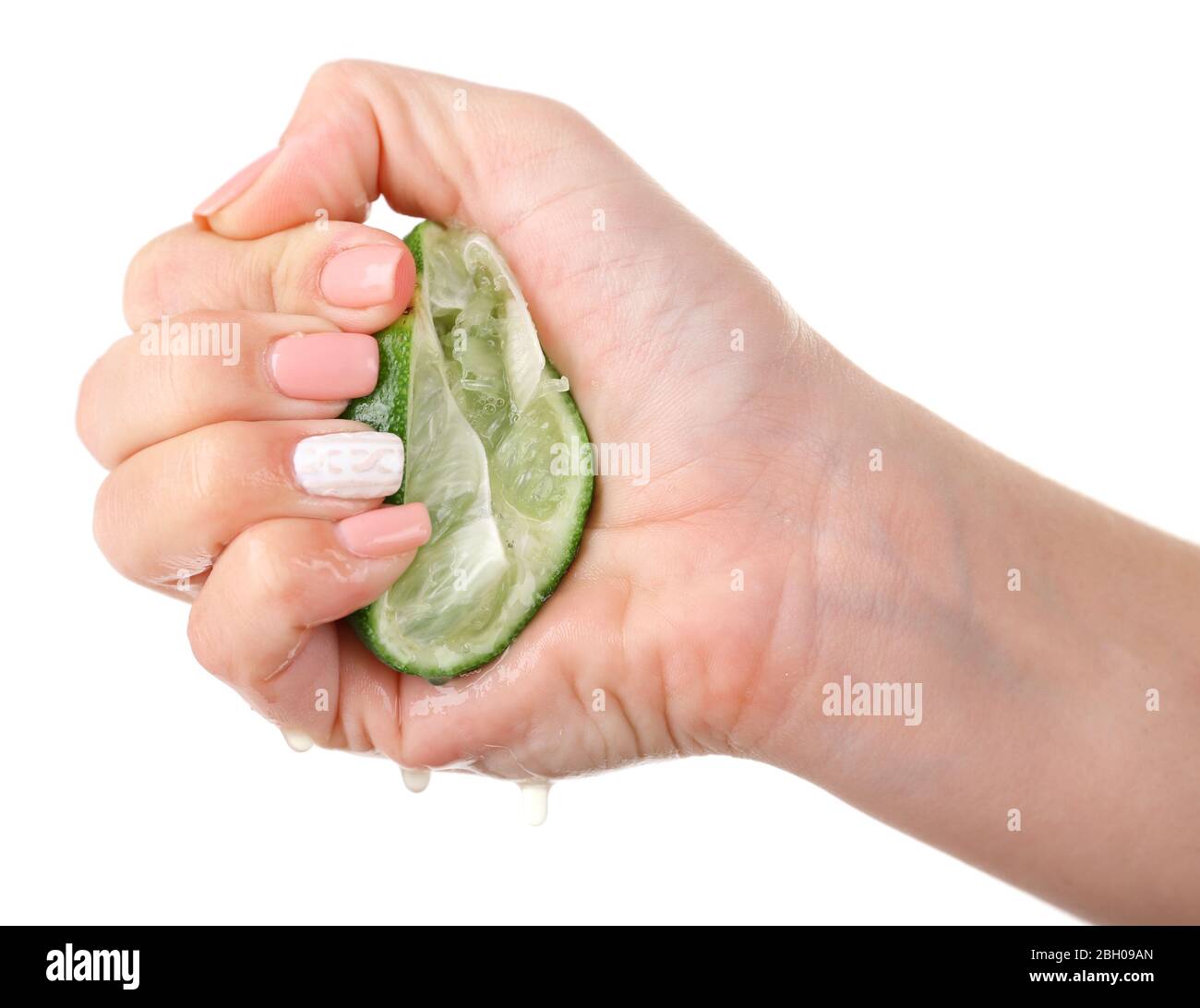 Female hand squeezing lime isolated on white Stock Photo - Alamy