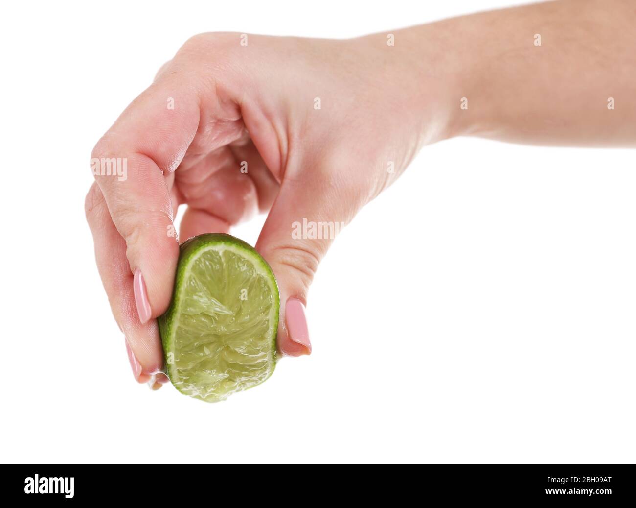 Female hand squeezing lime isolated on white Stock Photo - Alamy