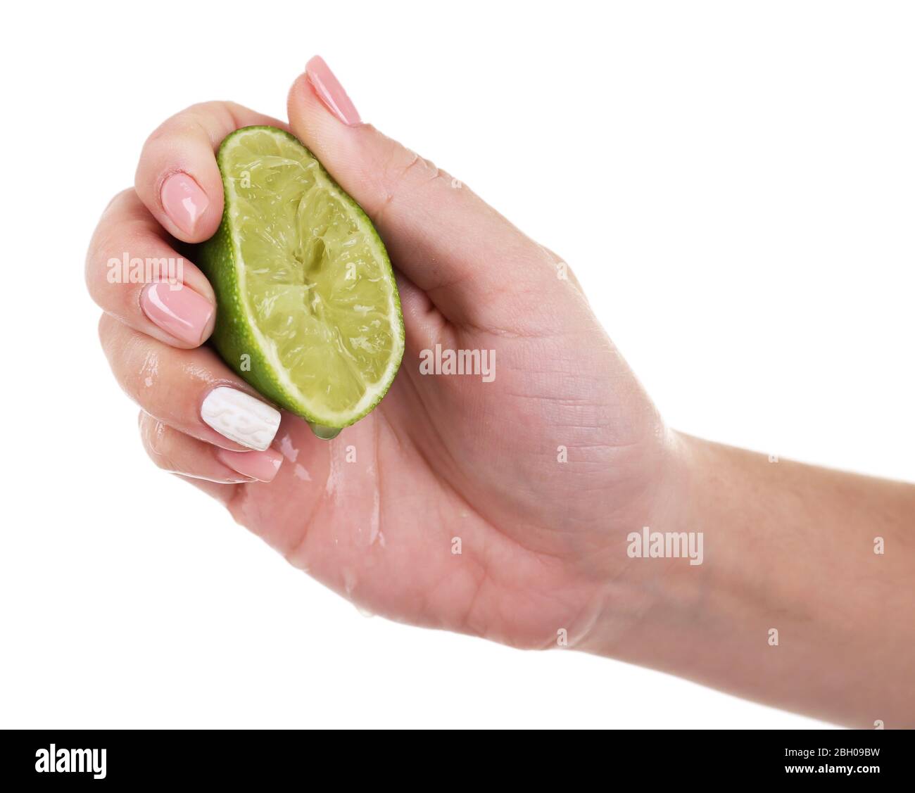 Female hand squeezing lime isolated on white Stock Photo - Alamy