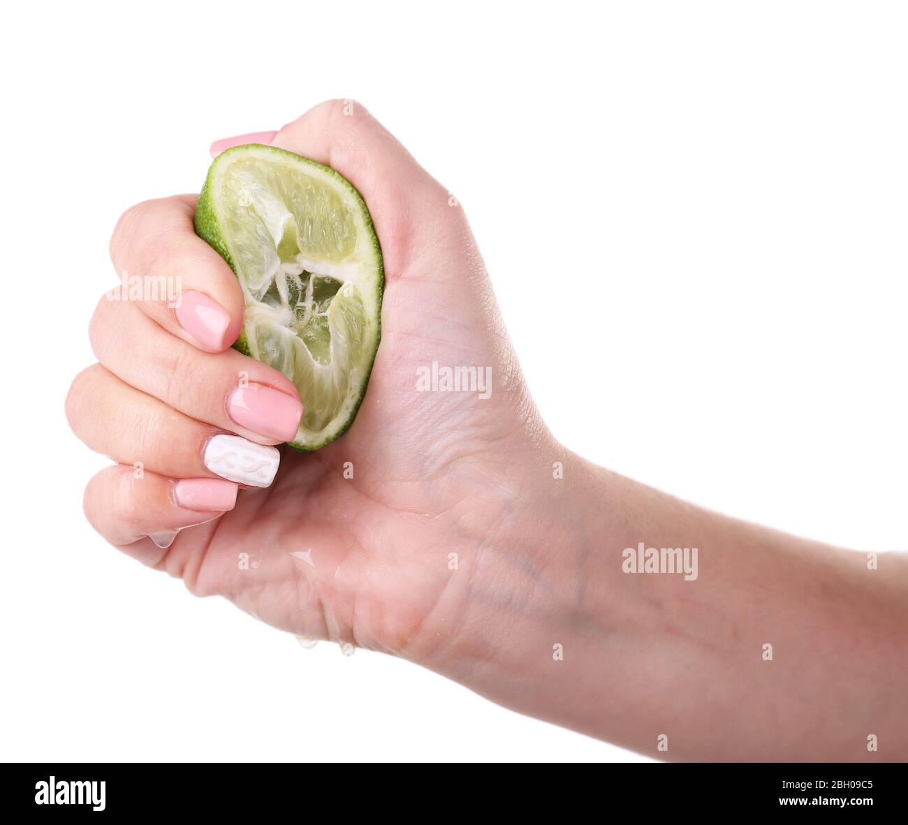 Female hand squeezing lime isolated on white Stock Photo - Alamy
