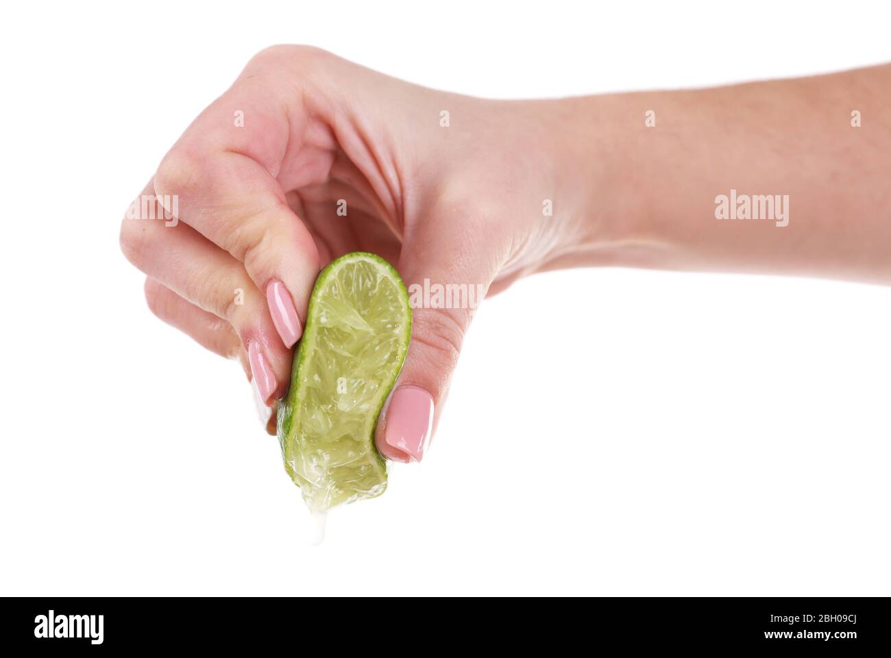 Female hand squeezing lime isolated on white Stock Photo - Alamy
