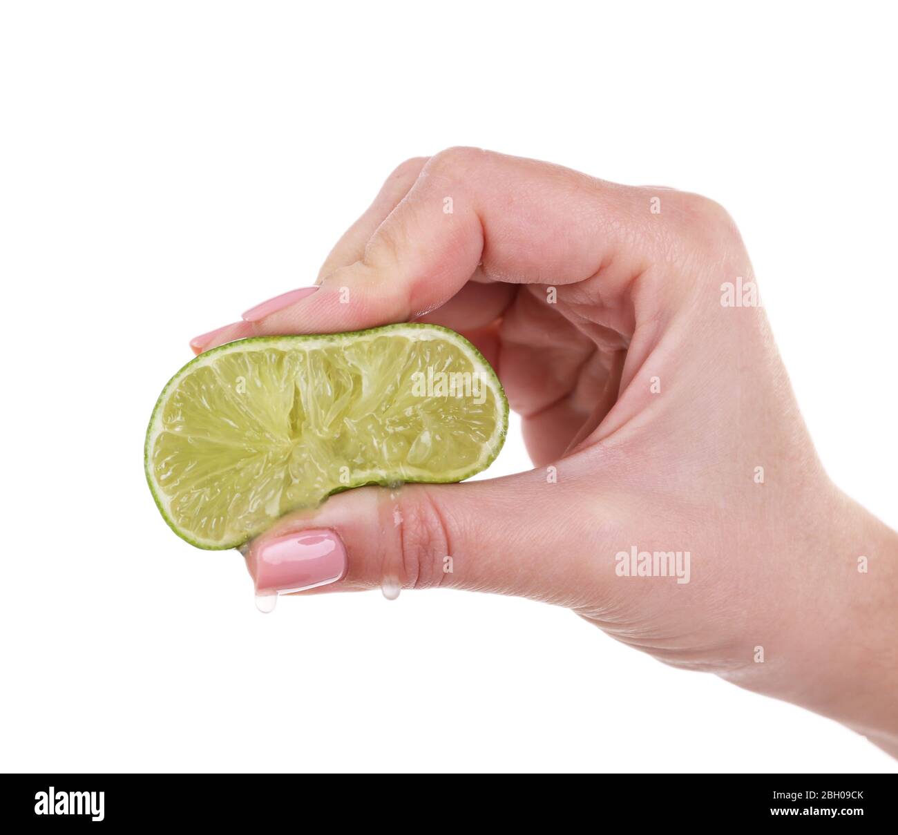 Female hand squeezing lime isolated on white Stock Photo - Alamy