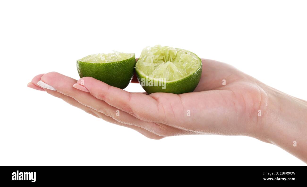 Female hand holding two pieces of lime isolated on white Stock Photo ...