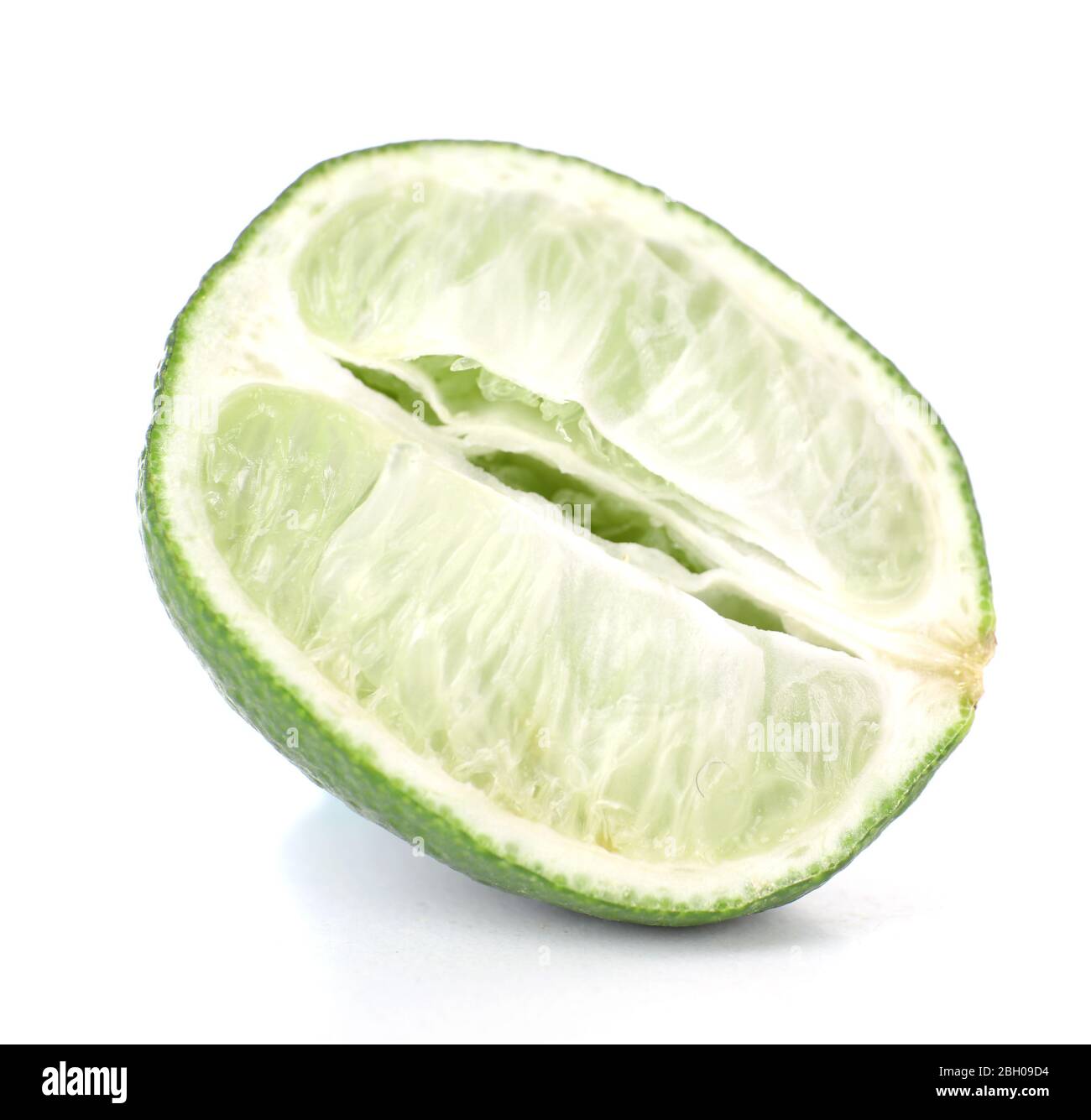 Squeezed lime isolated on white Stock Photo - Alamy