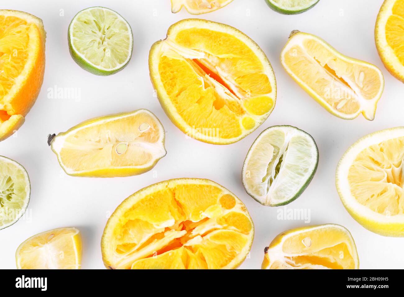 Squeezed citrus fruits isolated on white Stock Photo - Alamy