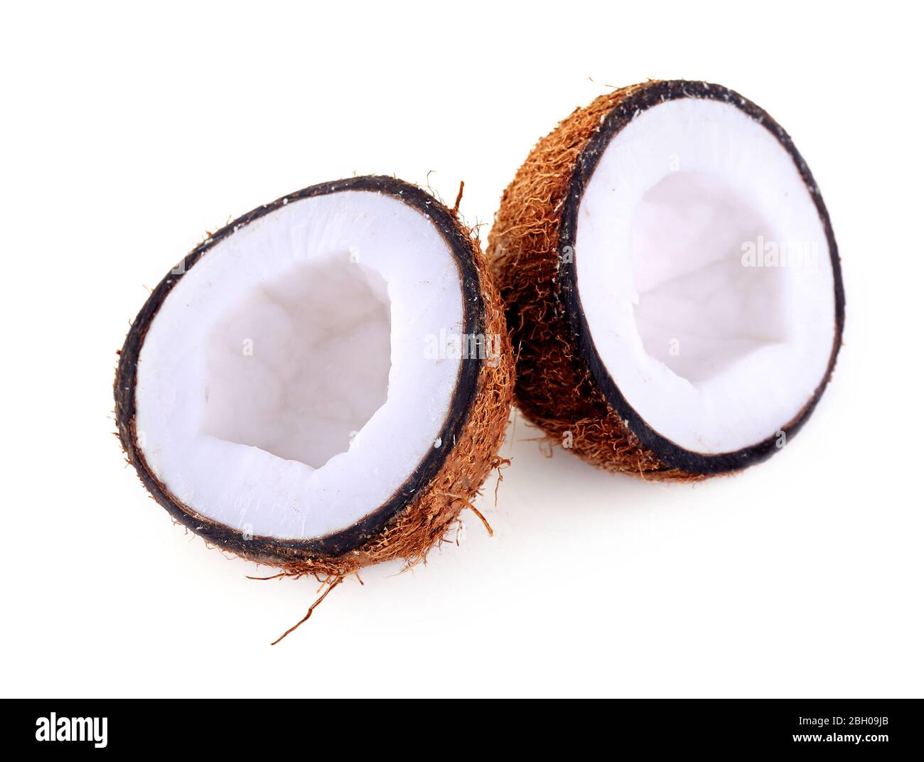 Coconut cut in half isolated on white background Stock Photo - Alamy