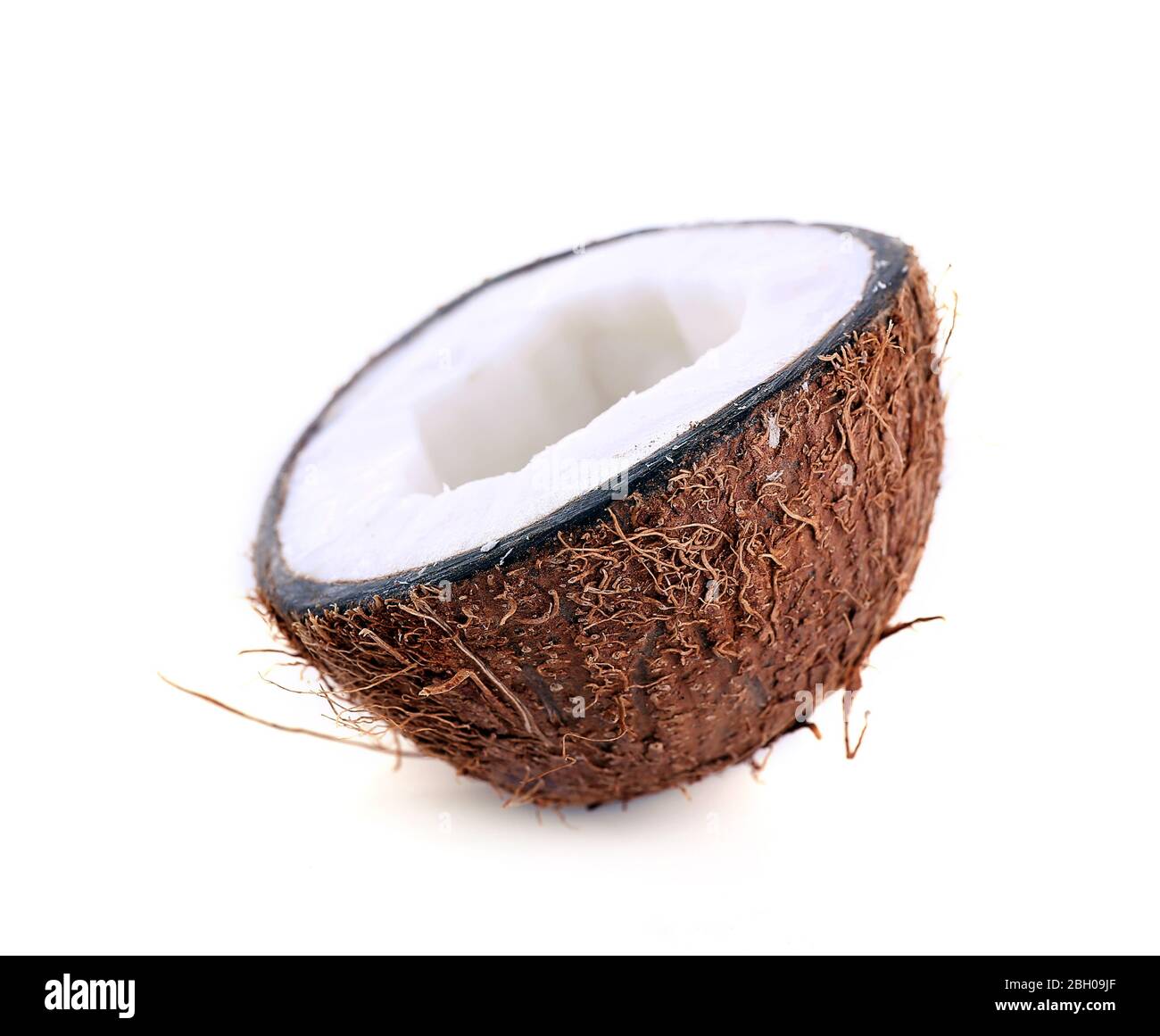 Coconut cut in half isolated on white background Stock Photo - Alamy