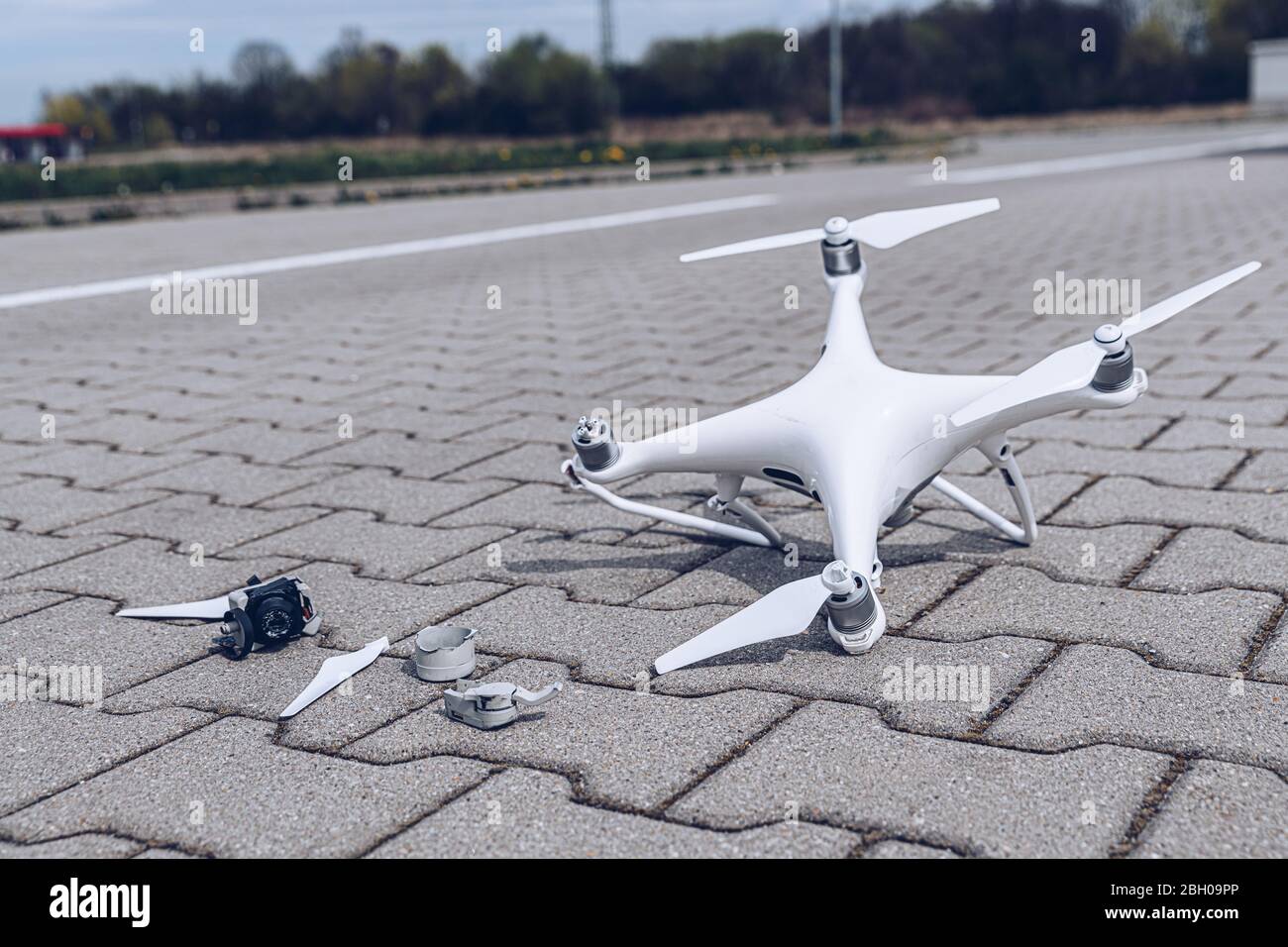 Crashed modern drone and camera after drone accident Stock Photo - Alamy