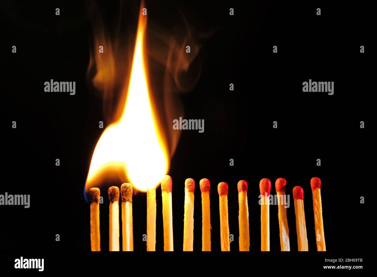 Line of lighted matches on black background Stock Photo - Alamy