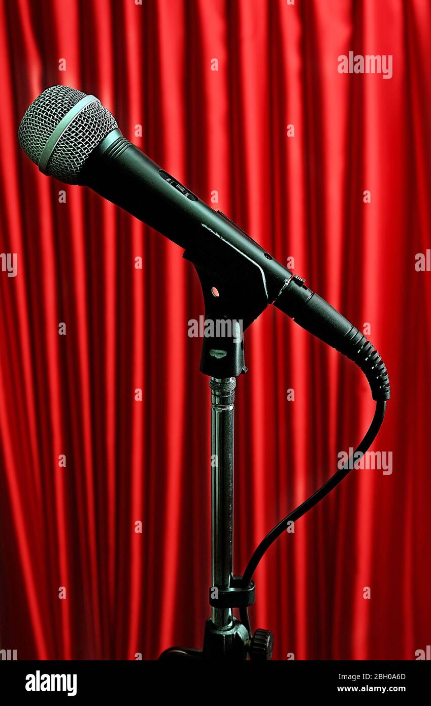Microphone on stand on red curtain background Stock Photo - Alamy